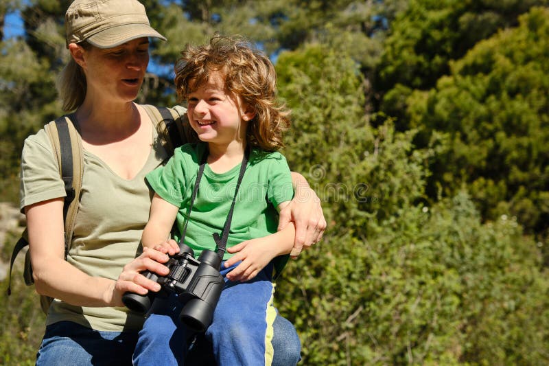 Mother Exploring Nature with Her Son by Showing Him the Plants Stock ...