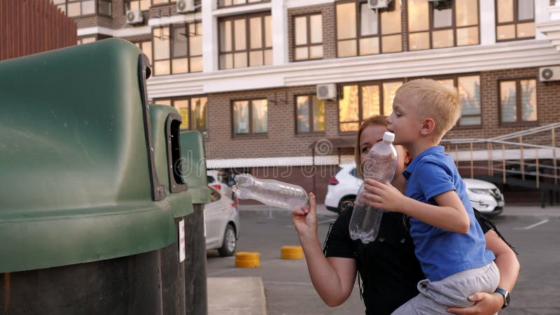 A Boy and a Girl are Sitting on the Playground in a Tunnel of Ropes and ...