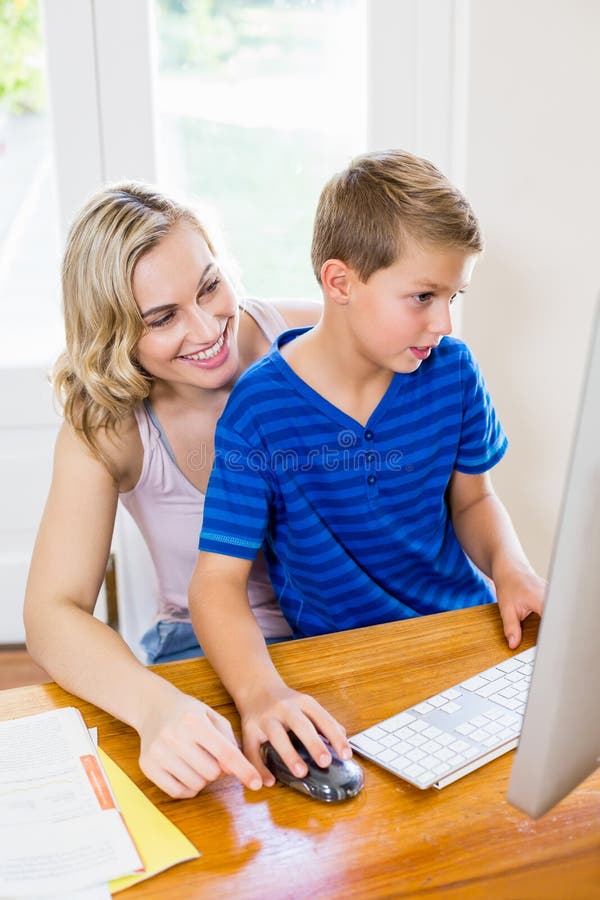 Mother and Son Using Computer in Living Room Stock Photo - Image of ...