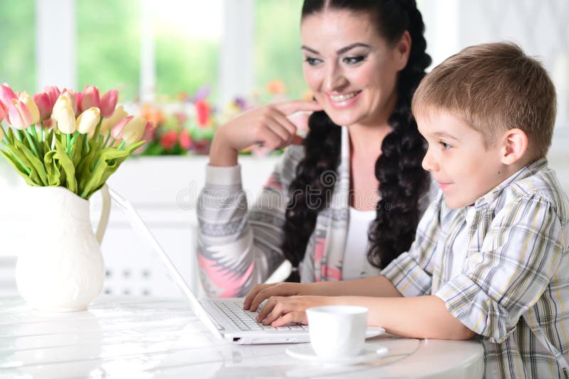 Mother and Son Using Modern Laptop at Home Stock Photo - Image of ...
