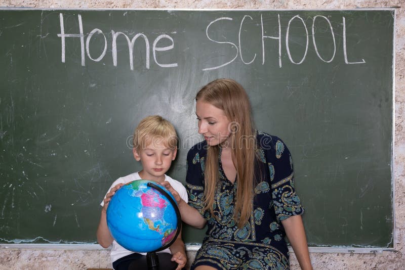 Mother is Studying a World Map on a Globe with Her Son. Stock Image ...