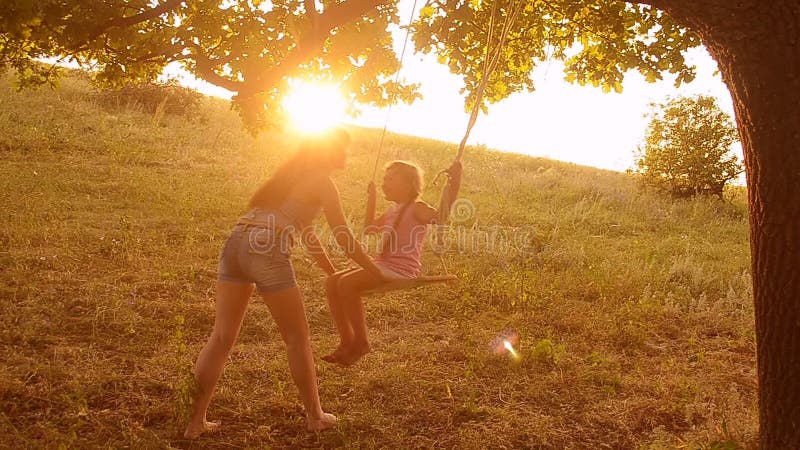 Mother Swings the Daughter on a Swing Stock Video - Video of quickly ...