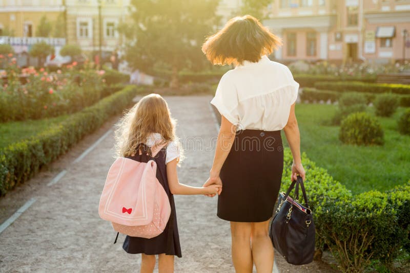 Mother Taking Daughter To School - Back View. Stock Image - Image of ...