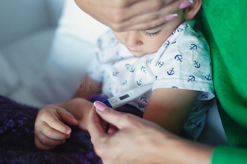 Mother Taking Temperature To Son and Holding Forehead at Home Stock ...