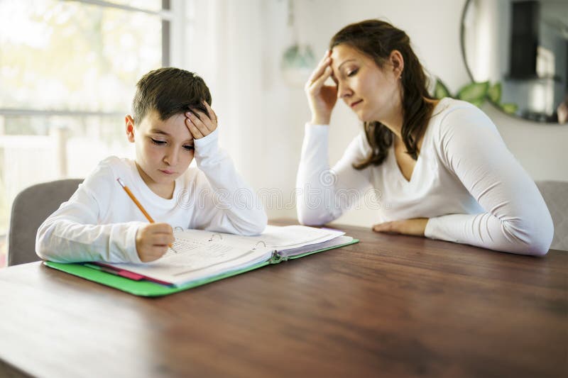 Mother Teaching Bored Son and Helping with Homework at Home Stock Image ...