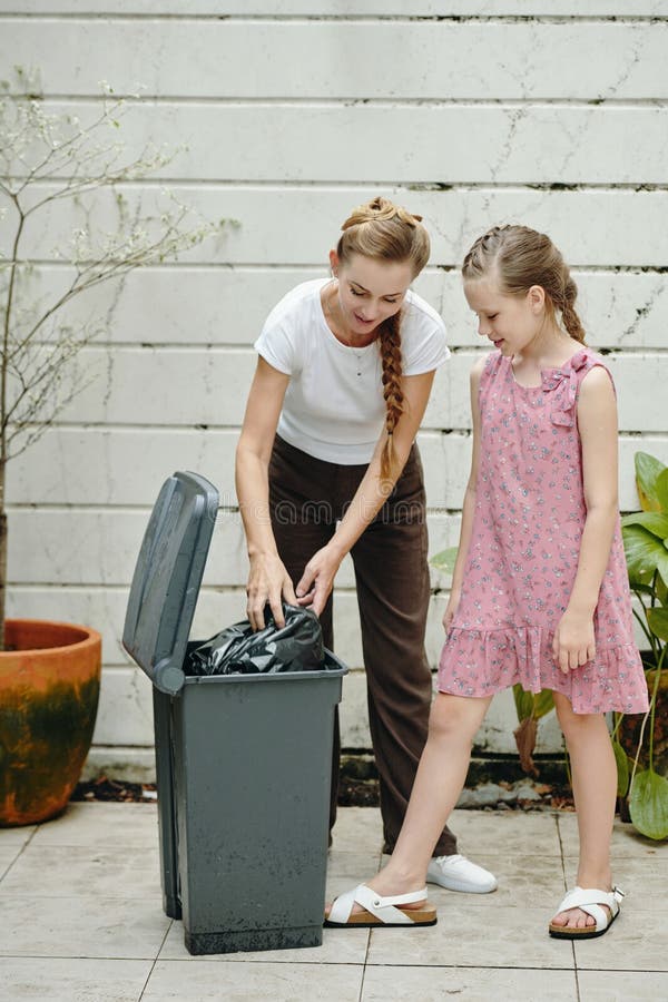 Mother Teaching Daughter To Throw Rubbish Stock Image - Image of clean ...