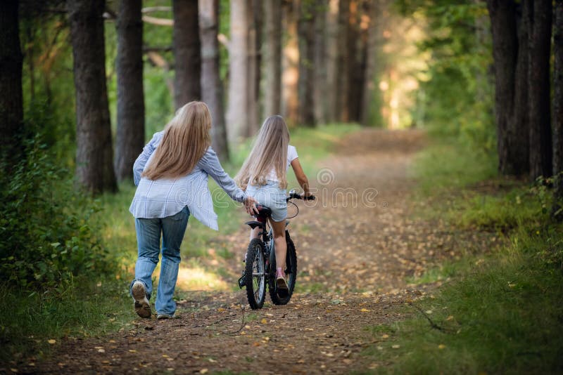 Mother Teaching Her Daughter Cycling in a Forest Outdoors Stock Image ... Mother Teaching Her Daughter Cycling in a Forest Outdoors Stock Image ...