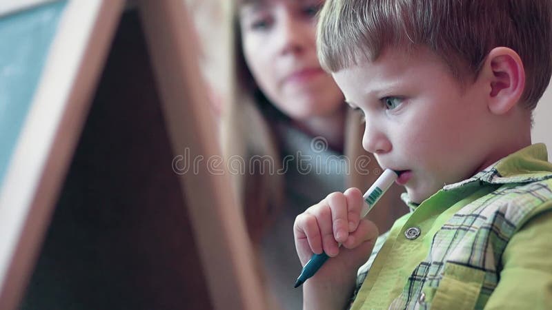 Mother Tells Her Son that he Needs To Write on the Board Stock Video ... Mother Tells Her Son that he Needs To Write on the Board Stock Video ...