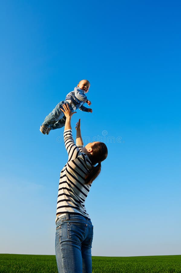 Mother Tossing Up Her Little Boy Stock Image - Image of outdoors ...