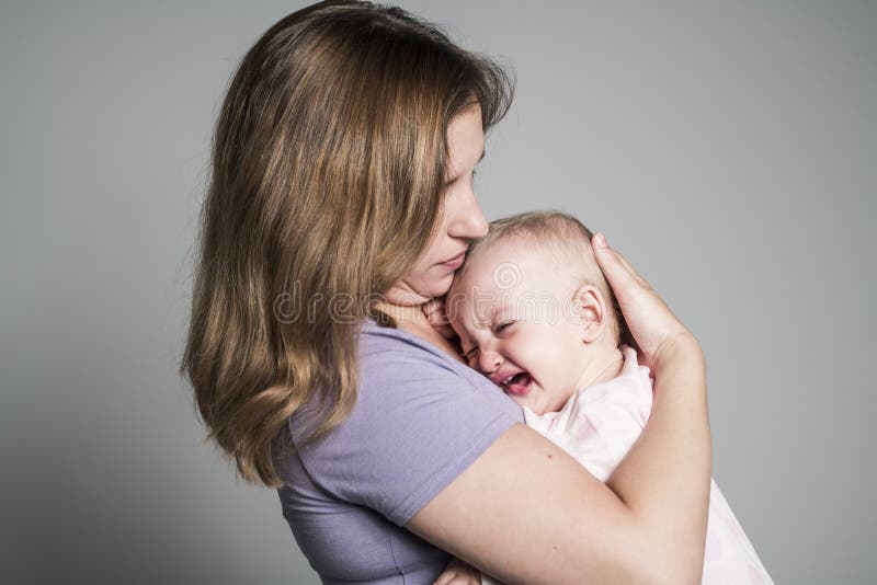 Mother Trying To Calm Her Crying Baby Stock Image - Image of family ...