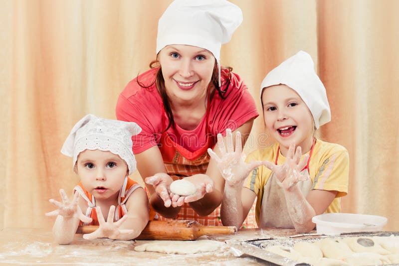 Mother with Two Daughters Baking Bread. Stock Image - Image of activity ...