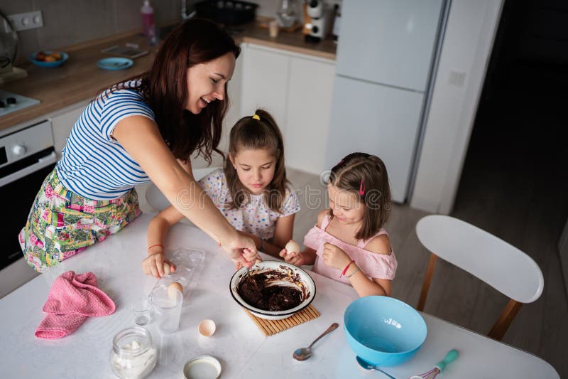 Mother and Daughters Baking Cupcakes Together in the Kitchen Stock ...