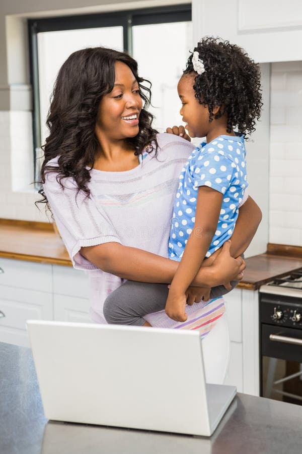 Mother Using Laptop while Carrying Kid Stock Photo - Image of laptop ...