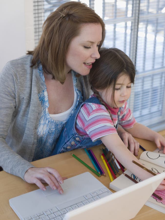 Mother Using Laptop Daughter Coloring Book Table Stock Photos - Free ...