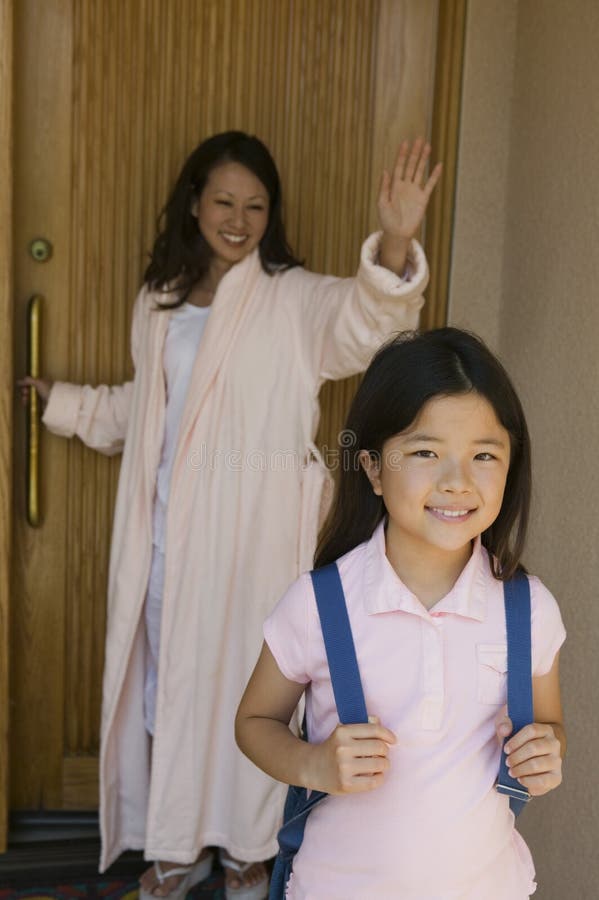 Mother Waving Goodbye To Daughter Stock Photo - Image of door, mother ...