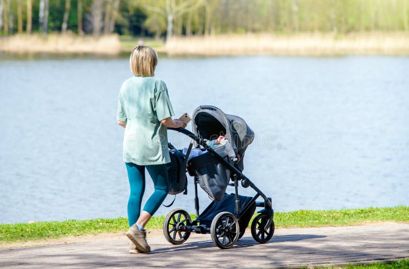 Mother Wheeling a Pram in the Park .Mother Wheeling a Pram in the Park ...
