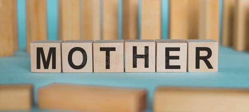 MOTHER Word Written on Wooden Blocks on Light Blue Background Stock ...