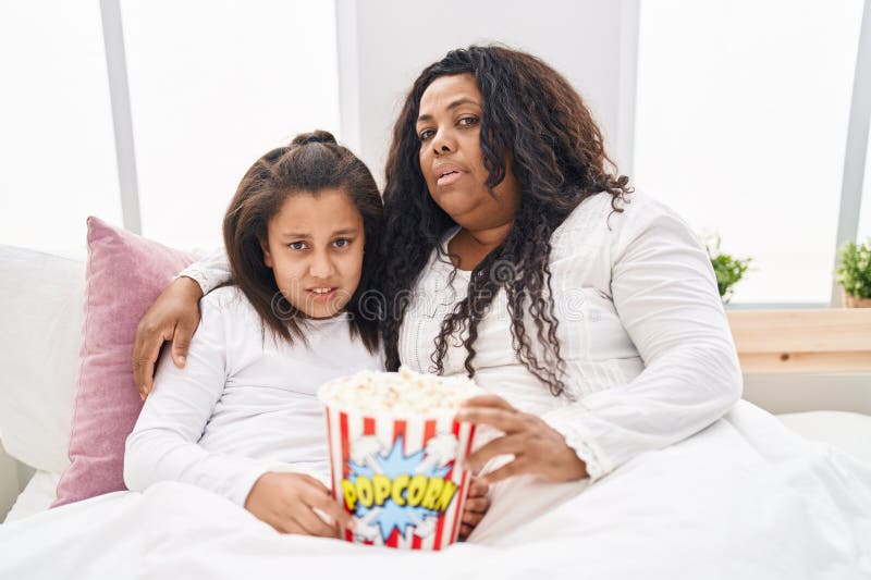 Mother and Young Daughter Eating Popcorn in the Bed Clueless and ...