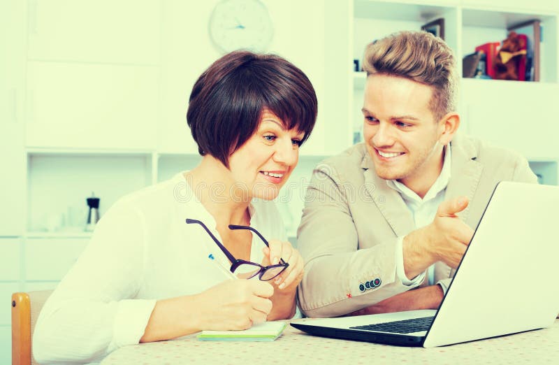 Mother and Young Son Consider Software on Laptop Stock Photo - Image of ...
