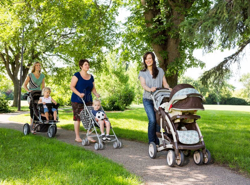 Mothers with Baby Strollers Walking in Park Stock Image - Image of ...
