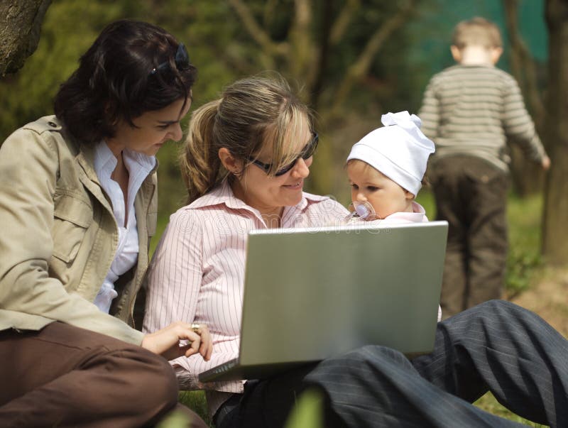 Mothers are using a laptop stock photo. Image of mothers - 2235430