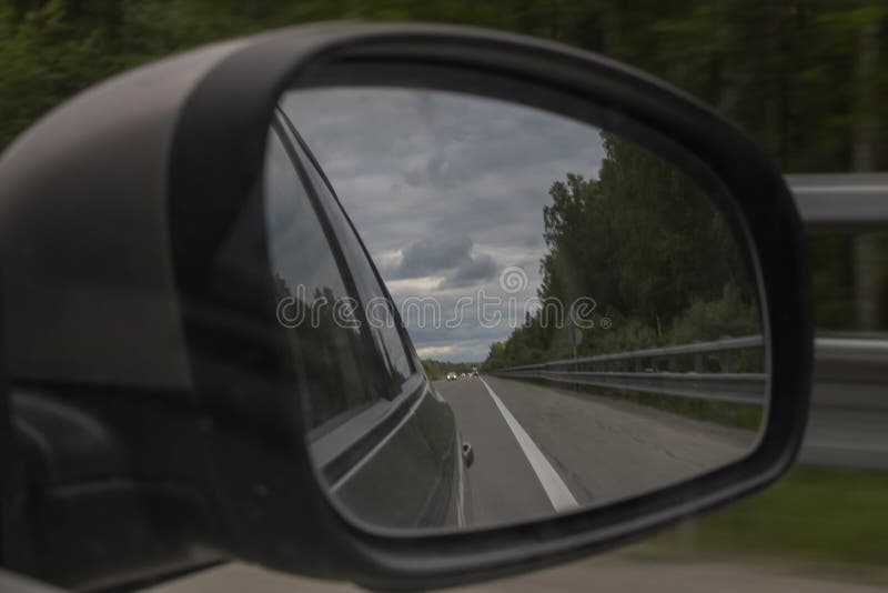 Motion Blur. View of the Forest Road through the Side Mirror of the Car ...