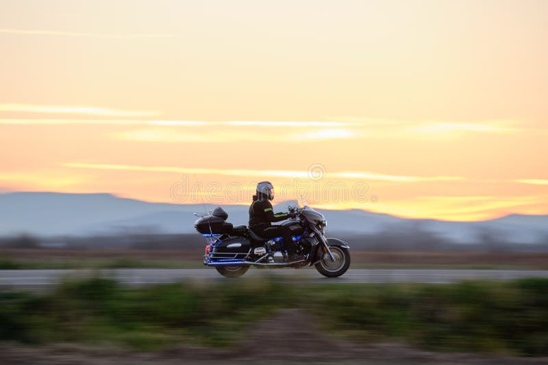 Motion Blurred Image of Motorcycle Driving Fast on Evening Road Stock ...