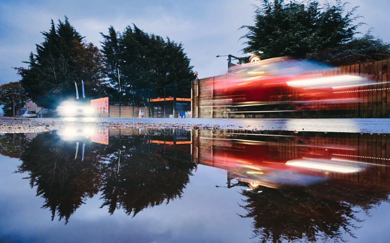 Blurred Car Reflection in Puddle Stock Image - Image of blue ...
