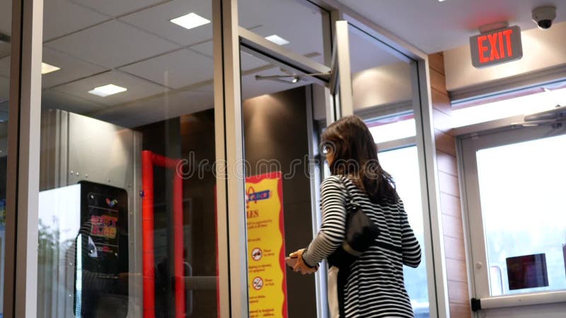 People are Entering a Room with Safe Deposit Boxes To Secure Valuable ...