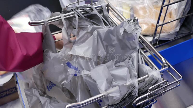 Motion of People Packing Foods at Check Out Counter Stock Video - Video ...