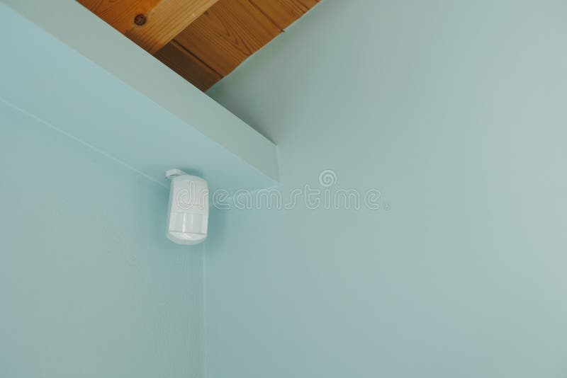 Motion Sensor or Detector for Security System Mounted on Blue Wall in ...