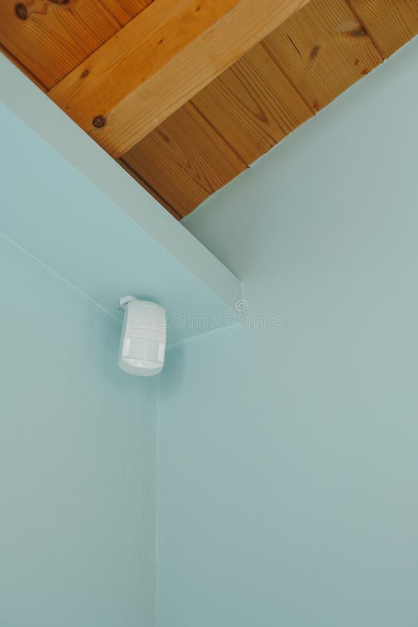 Motion Sensor or Detector for Security System Mounted on Blue Wall in ...