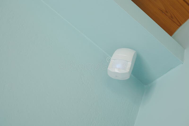 Motion Sensor or Detector for Security System Mounted on Blue Wall in ...