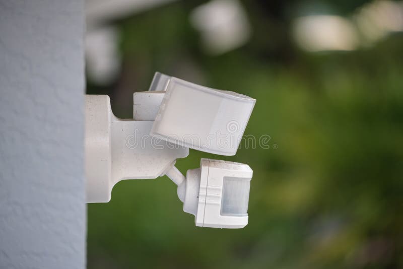 Motion Sensor with Light Detector Mounted on Exterior Wall of Private ...