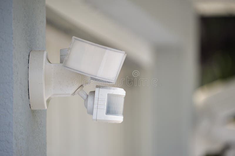 Motion Sensor with Light Detector Mounted on Exterior Wall of Private ...