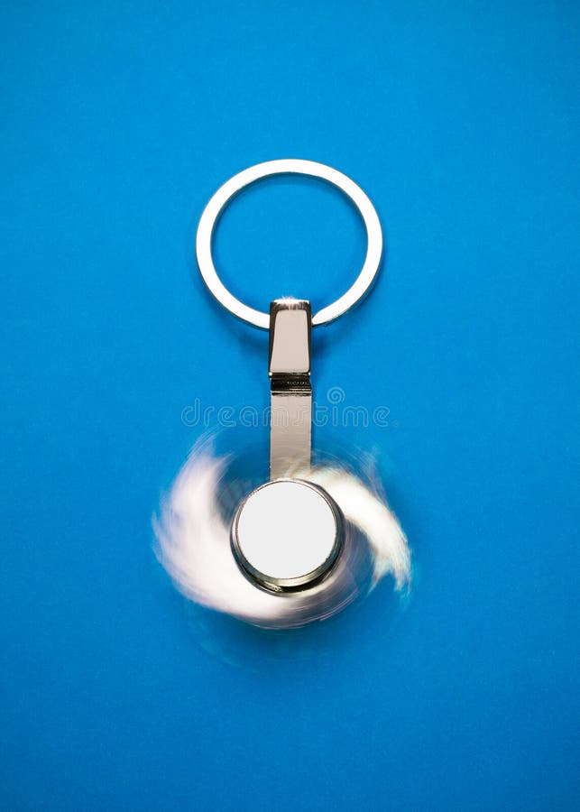 Motion of Spinning or Key Ring on Blue Paper Background. Blank Key ...