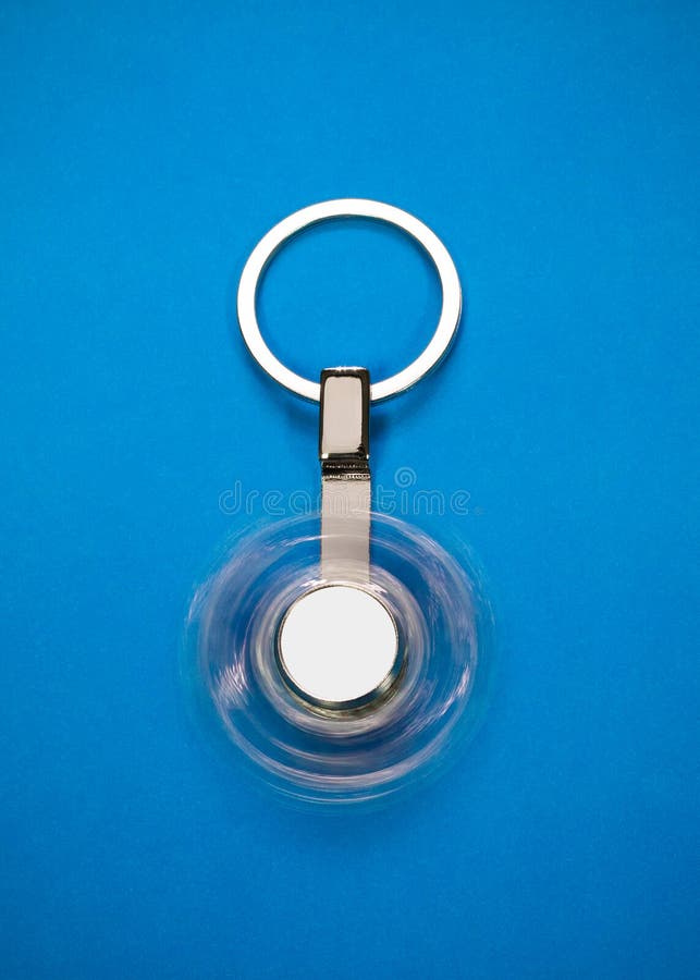 Motion of Spinning or Key Ring on Blue Paper Background. Blank Key ...