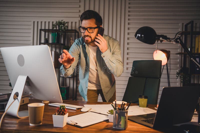 Young Professional Man Multitasking at Work in a Stylish Home Office ...