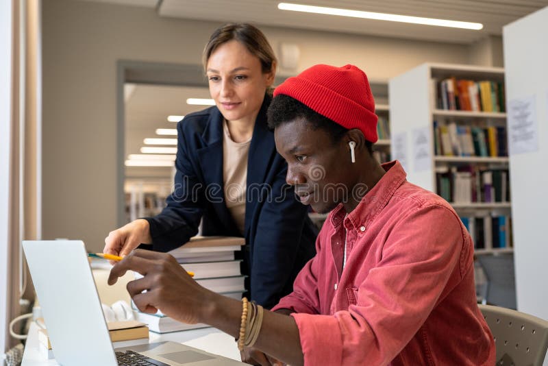 Personal Tutor Woman Assisting Puzzled Focused Student Black Guy in ...