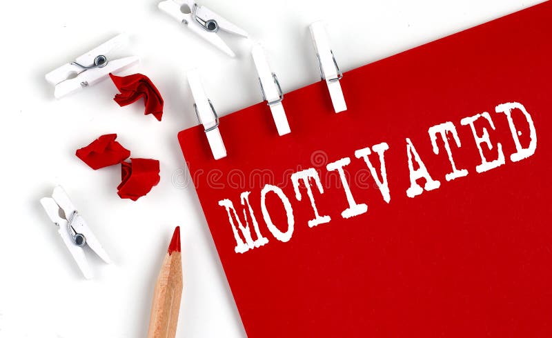 MOTIVATED Text on Red Paper with Office Tools on White Background Stock ...