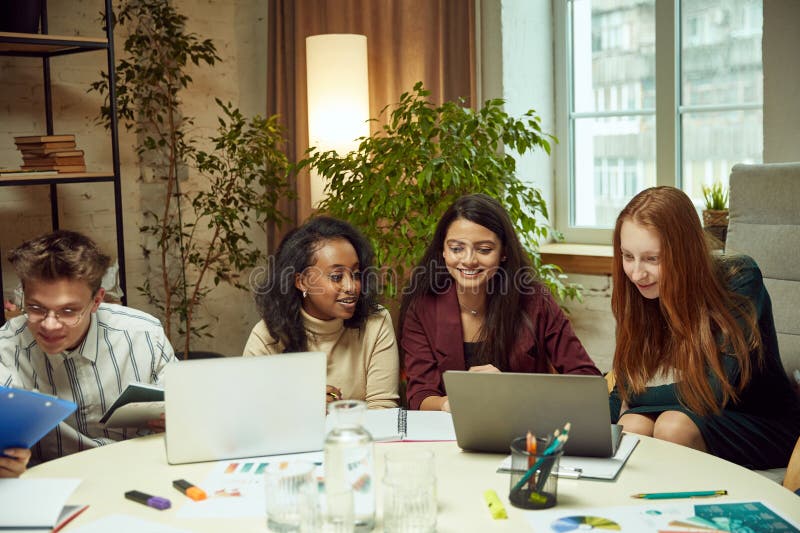 Motivated Young People, Students Sitting at Table with Laptops, Doing ...