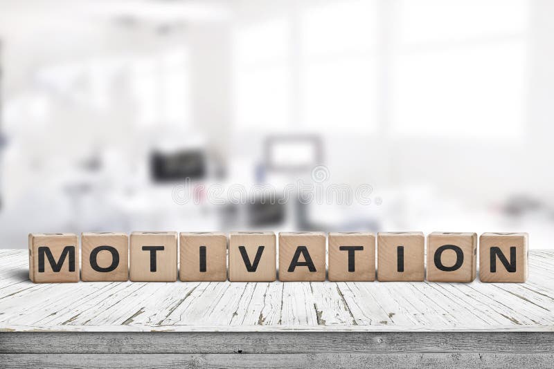 Motivation Sign on a Desk in a Bright Office Stock Photo - Image of ...