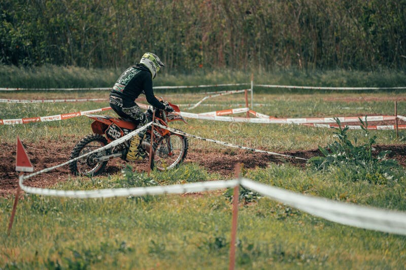 Motocross Rider in Action on a Dirt Track Surrounded by Greenery ...