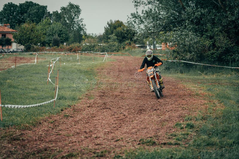 Motocross Rider in Action on a Dirt Track Surrounded by Greenery ...
