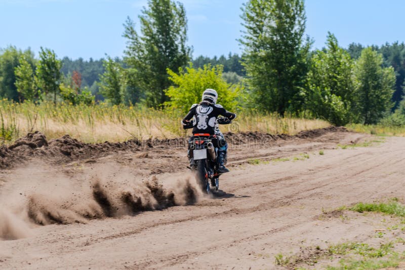 A Motocross Rider Riding on Extreme Dust Track Stock Photo - Image of ...