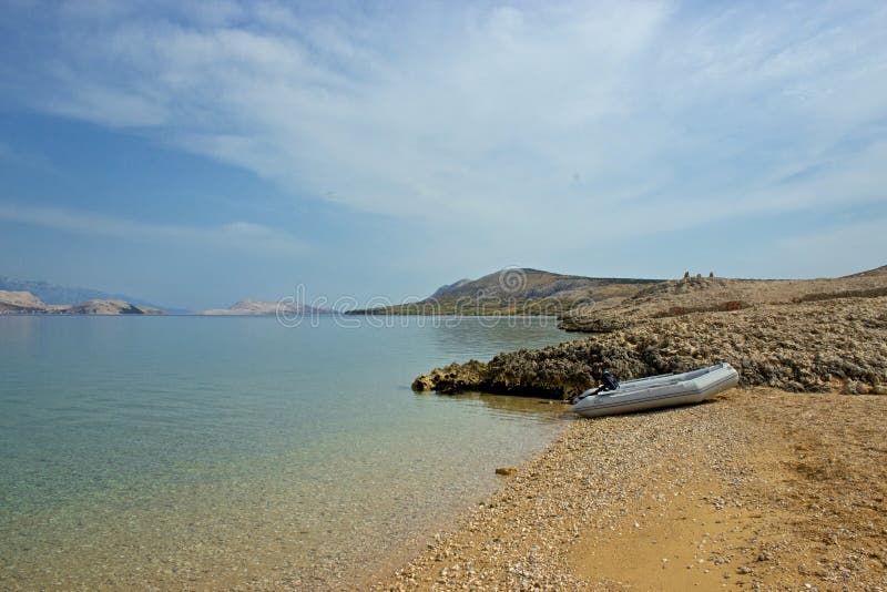 Motor Boat on Empty Sandy Beach in Blue Mountain Bay Stock Photo ...