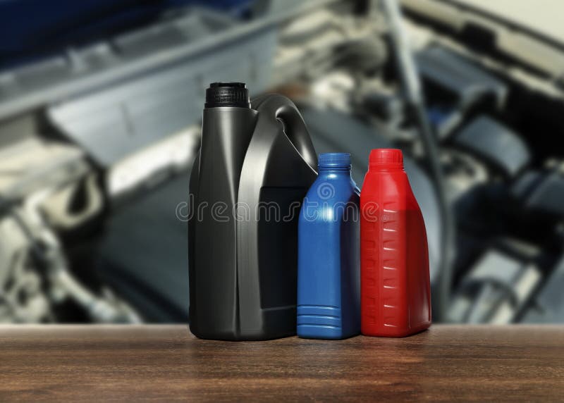 Motor Oil in Different Containers on Wooden Table Stock Photo - Image ...