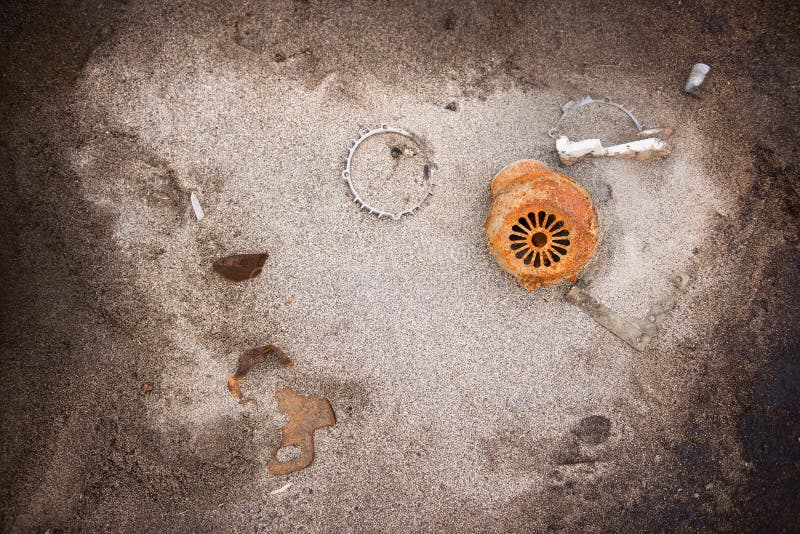 Motor parts on the sand stock photo. Image of detail - 98741646