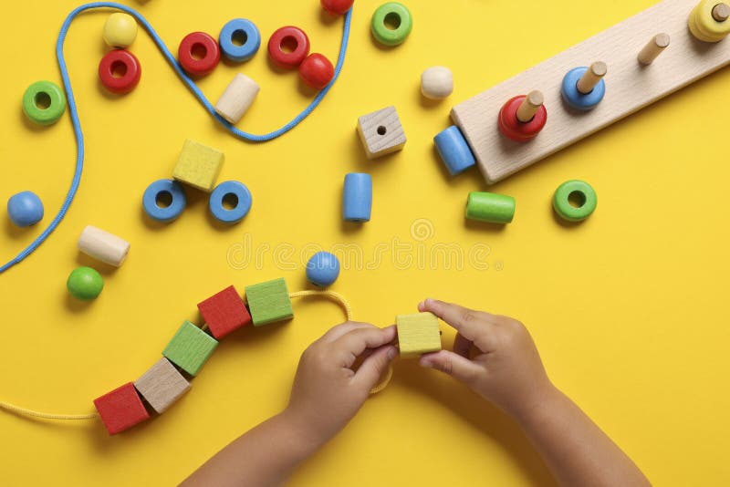 Motor Skills Development. Little Child Playing with Wooden Pieces and ...