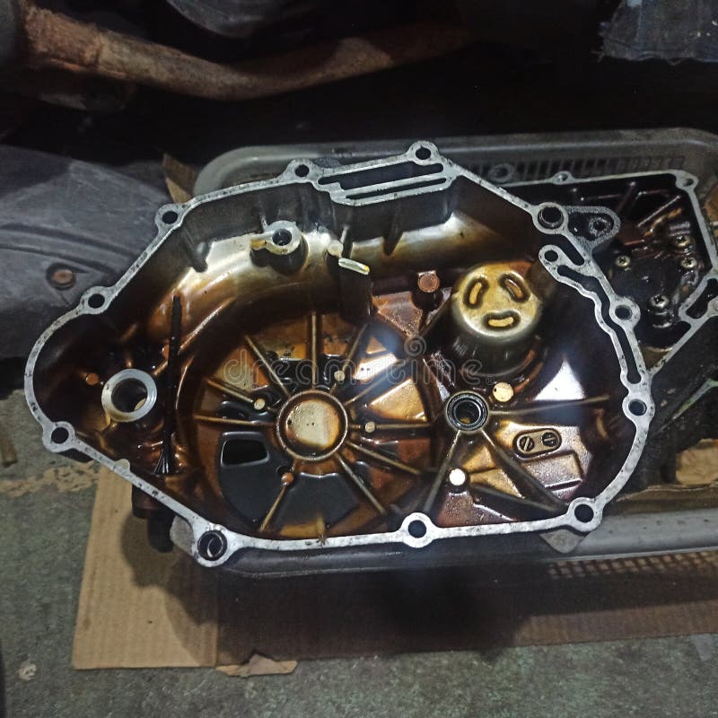 A Motorcycle Engine Casing, Stained with Dark Oil, Revealing Intricate ...